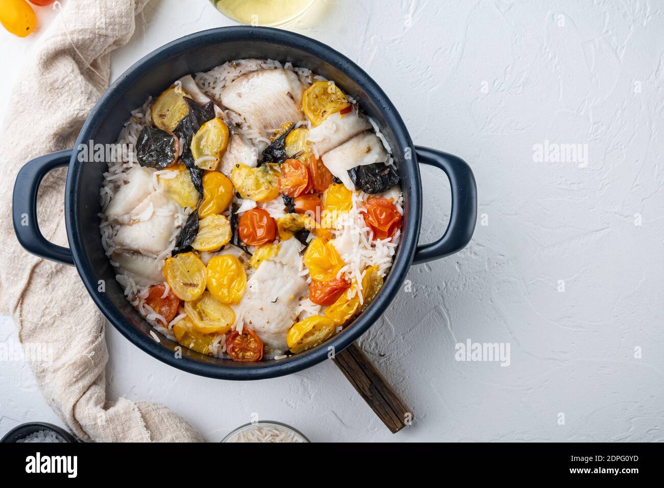 One pan fabulous fish, with basmati rice and cherry tomatoes, on white ...