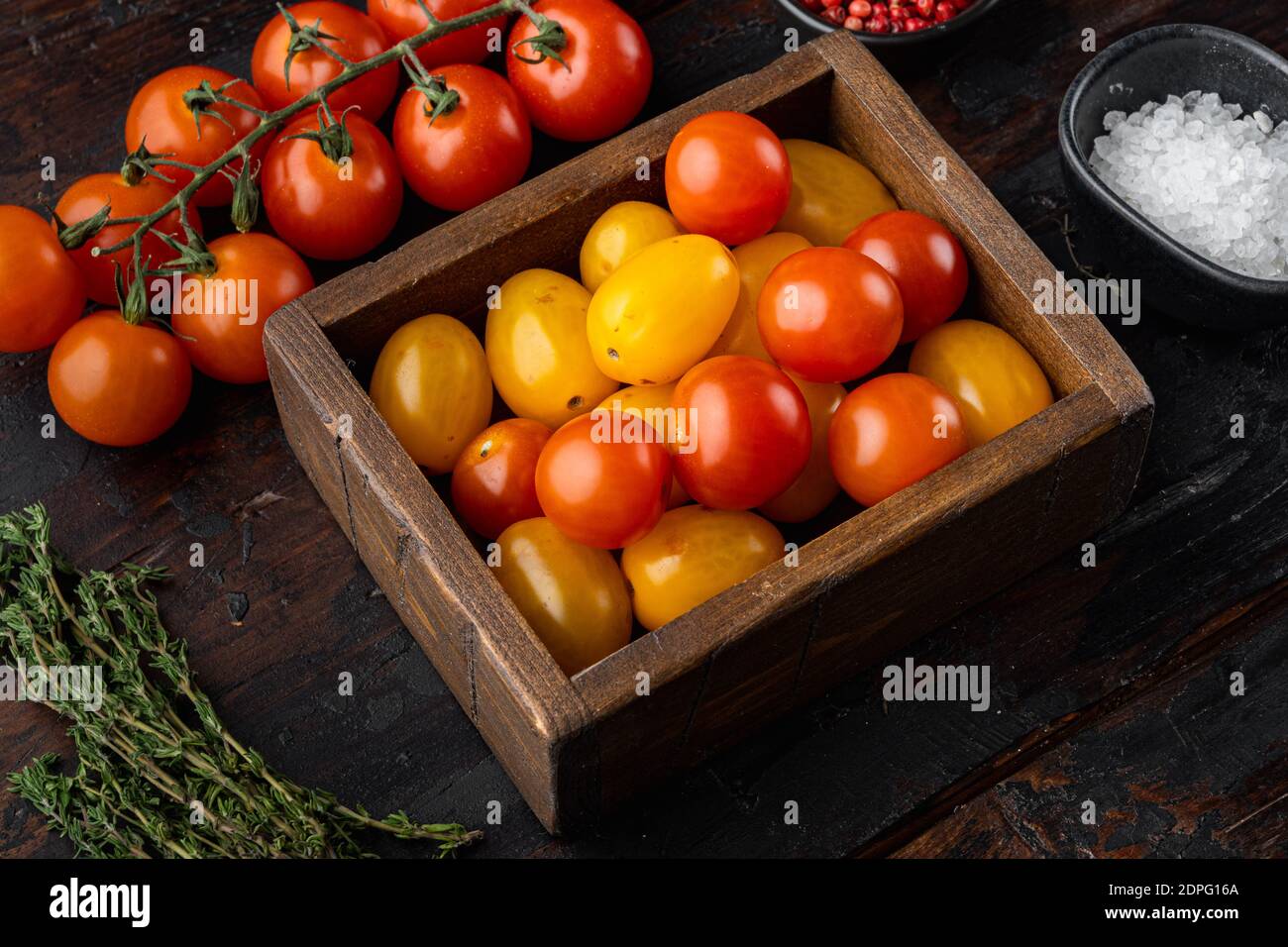 Mixed colour cherry tomatoes in wooden box, on old wooden table Stock ...