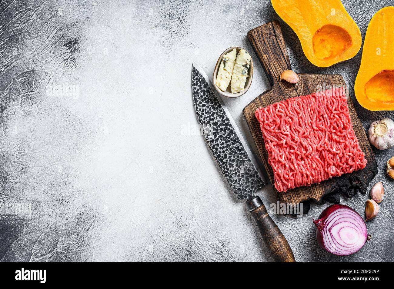 Raw mince meat, pumpkin with garlic and onion. White background. Top ...