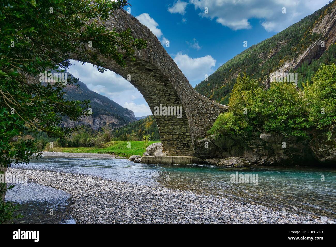 Roman bridge over river of rapid water in pyrenees Stock Photo - Alamy