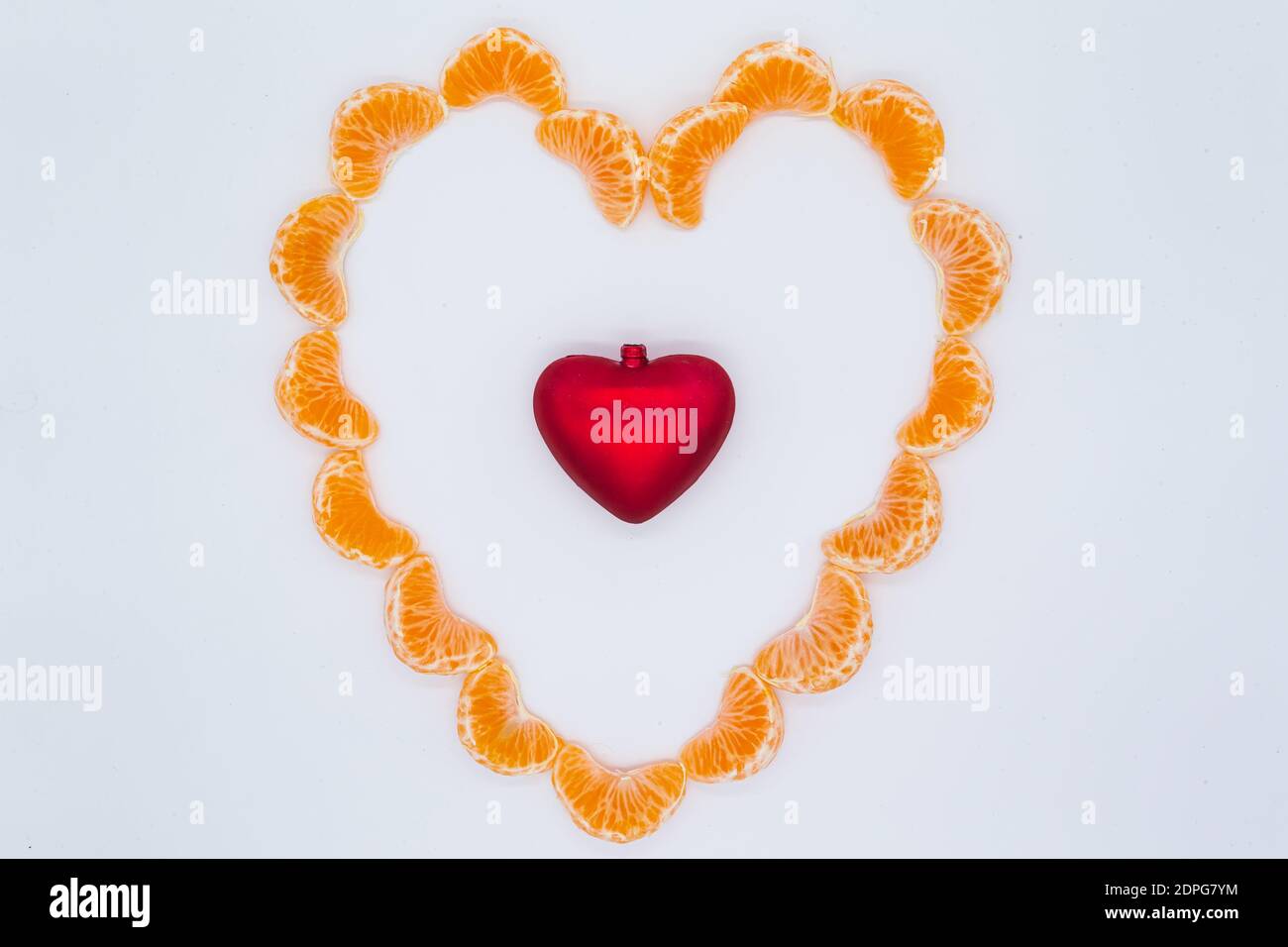 heart of mandarin segments cut on white background Stock Photo - Alamy