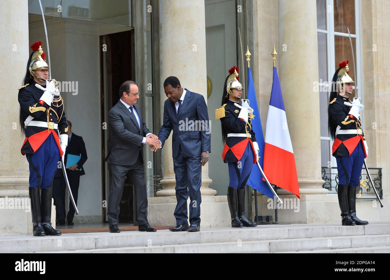French President Francois Hollande shakes hands with his Beninese ...