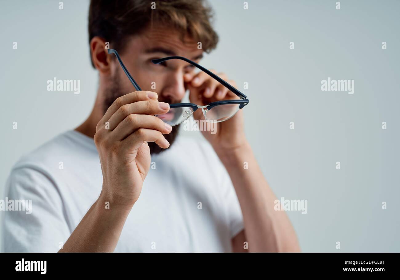 vision problems man holding glasses in hand pain in the eyes gray ...