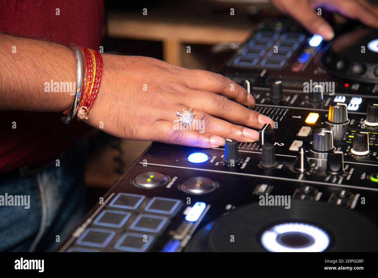 the hands of a DJ on equipment and vinyl record at party Stock Photo ...