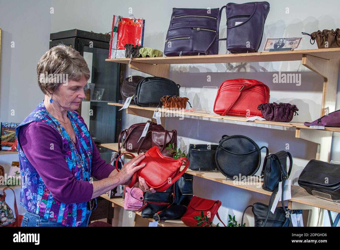 Woman shopping for a new pocketbook Stock Photo - Alamy
