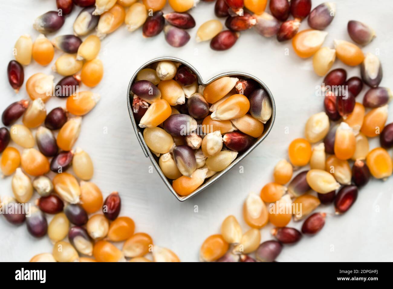 Multi Colored Popcorn Kernels in a Heart Shape Stock Photo - Alamy