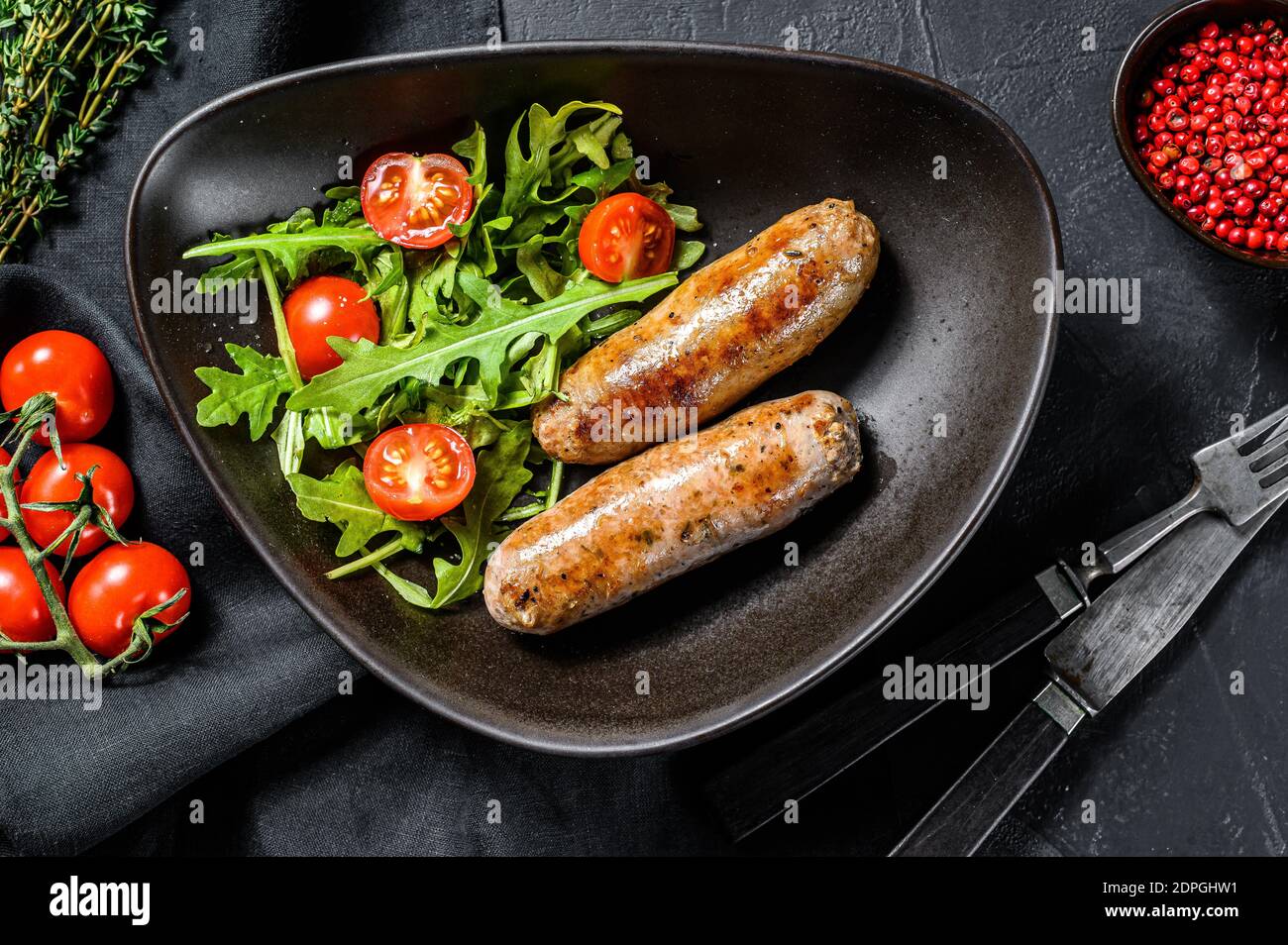 Grilled sausages with tomato and arugula salad. BBQ meat recipe. german ...