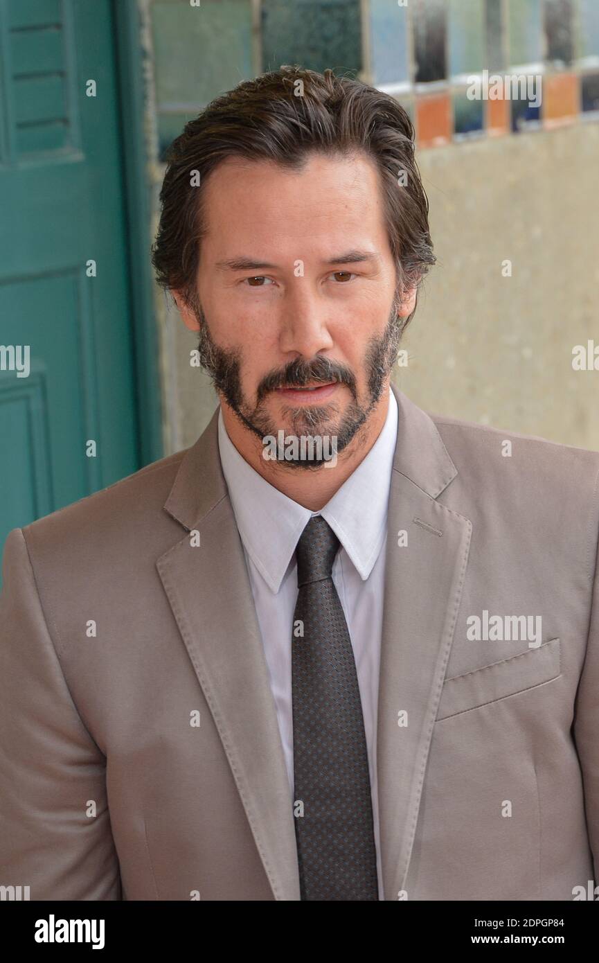 Keanu Reeves poses outside the beach cabin named after him as part of a ...