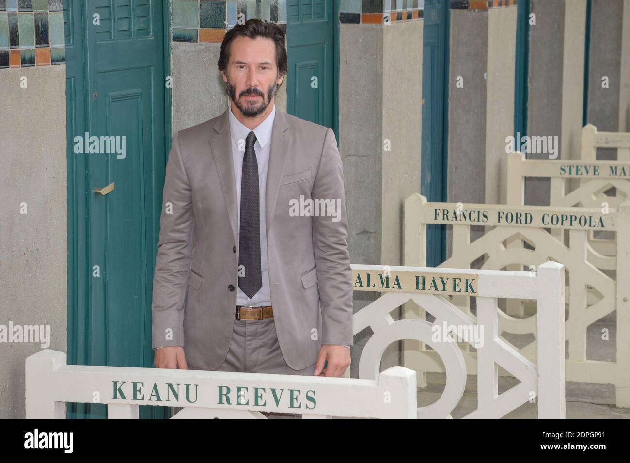 Keanu Reeves poses outside the beach cabin named after him as part of a ...