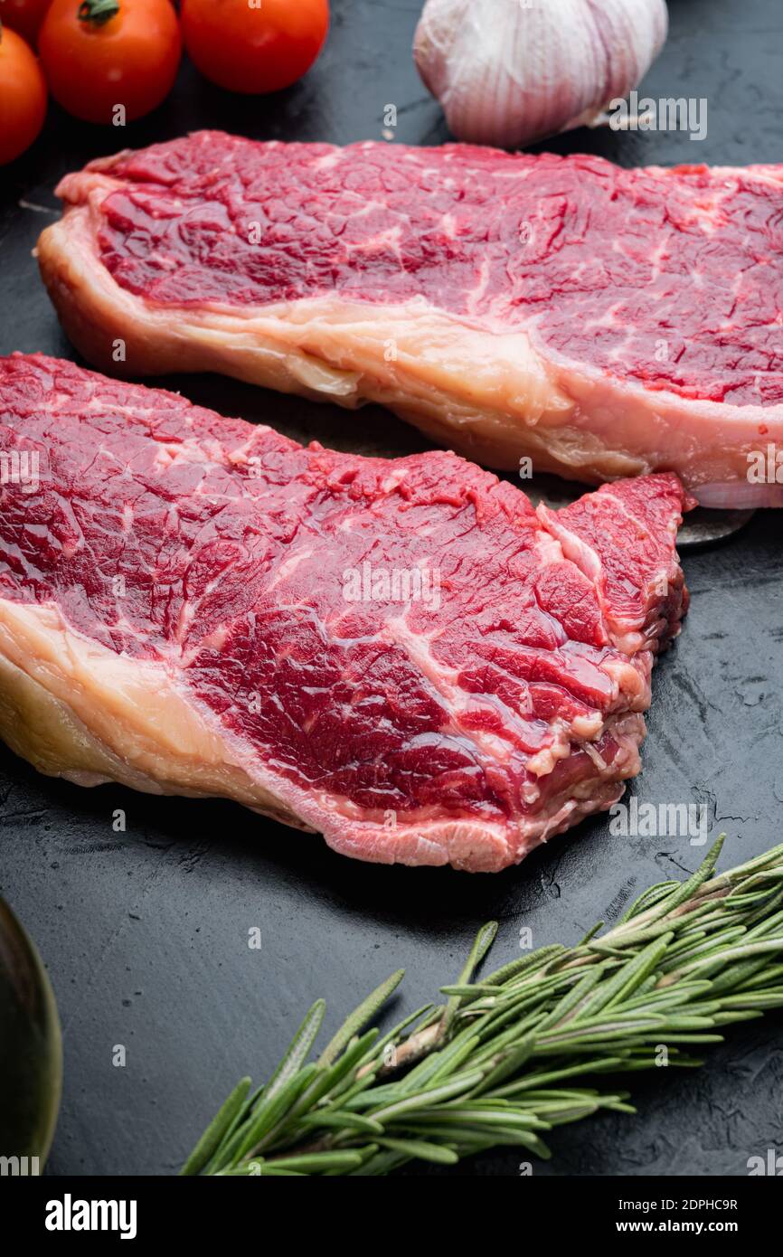 Striploin steak raw beef butchery cut, on black background Stock Photo ...