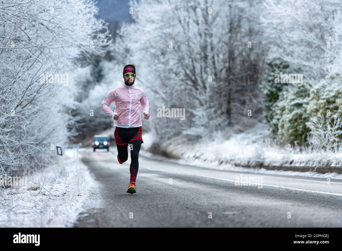 Mid adult man jogging on road hi-res stock photography and images - Alamy
