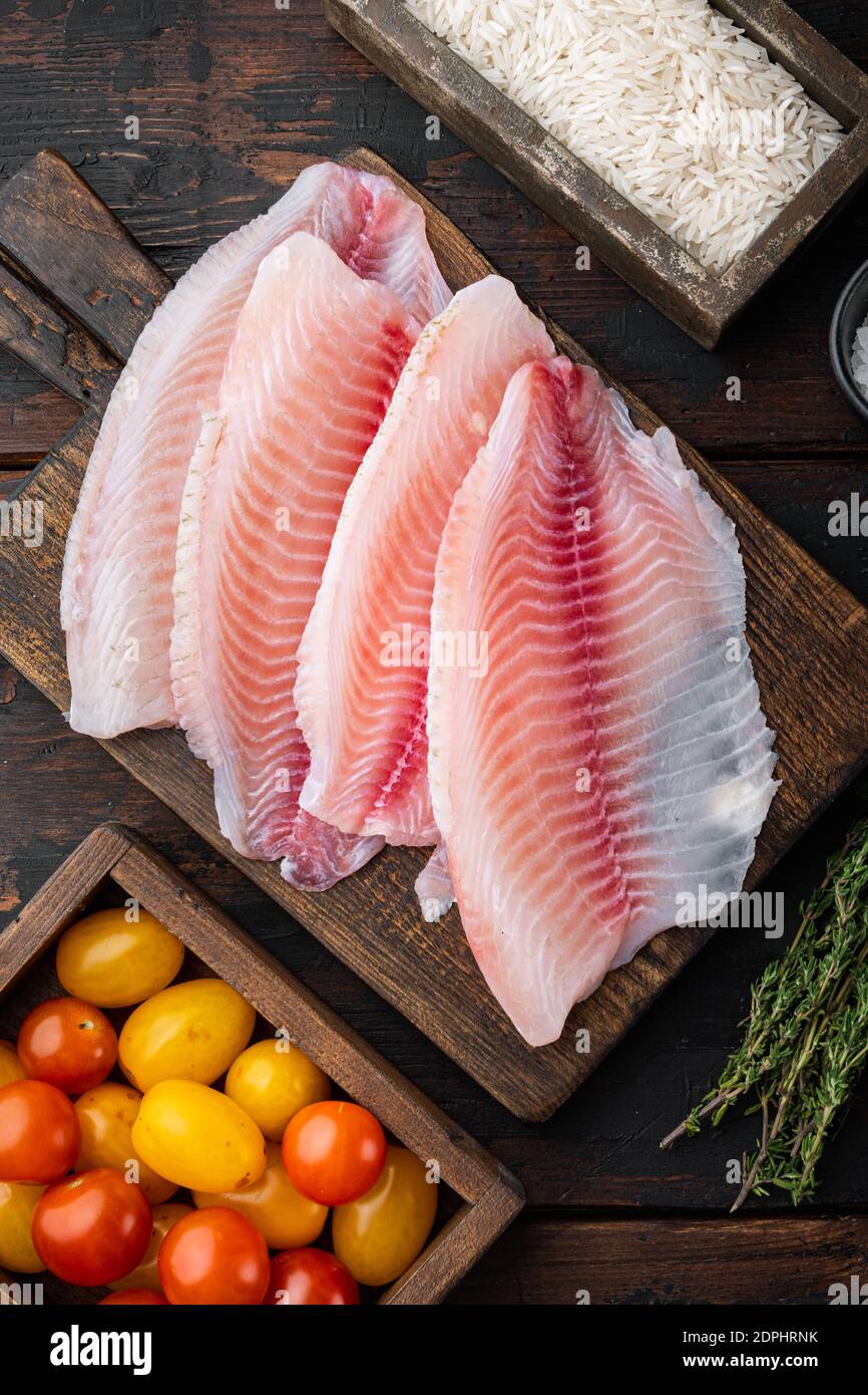 Raw white fish tilapia, with basmati rice and cherry tomatoes ...