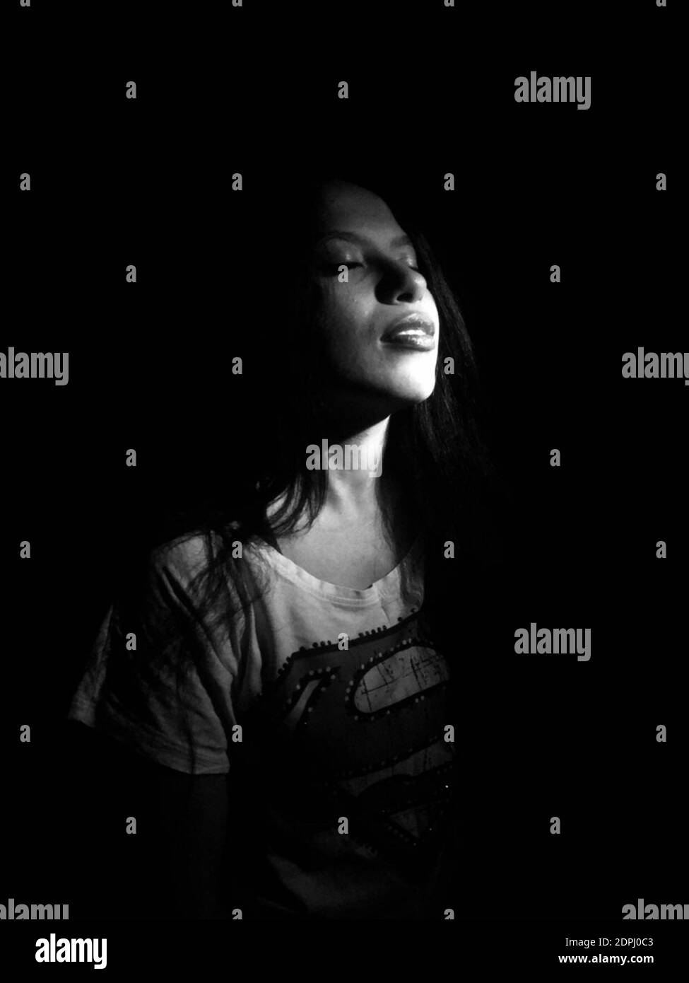 Young Woman Against Black Background Stock Photo - Alamy