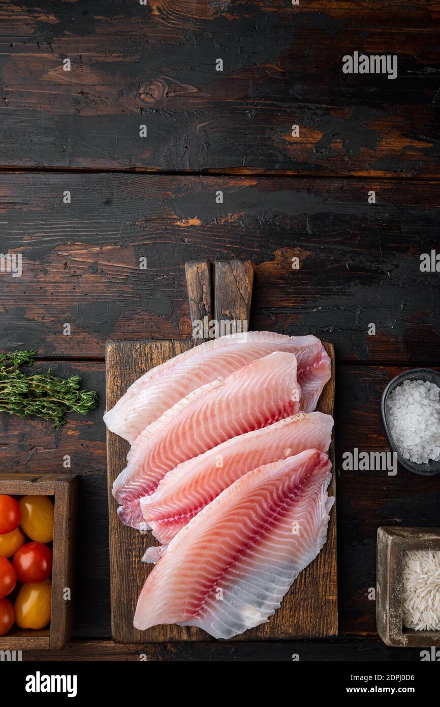 Raw white fish tilapia, with basmati rice and cherry tomatoes ...