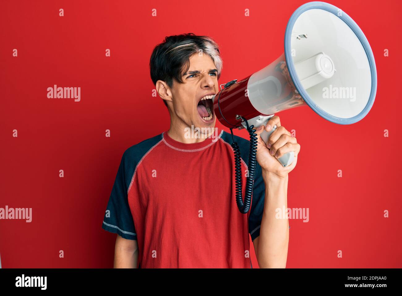 Young man shouting with anger and energy through megaphone Stock Photo ...