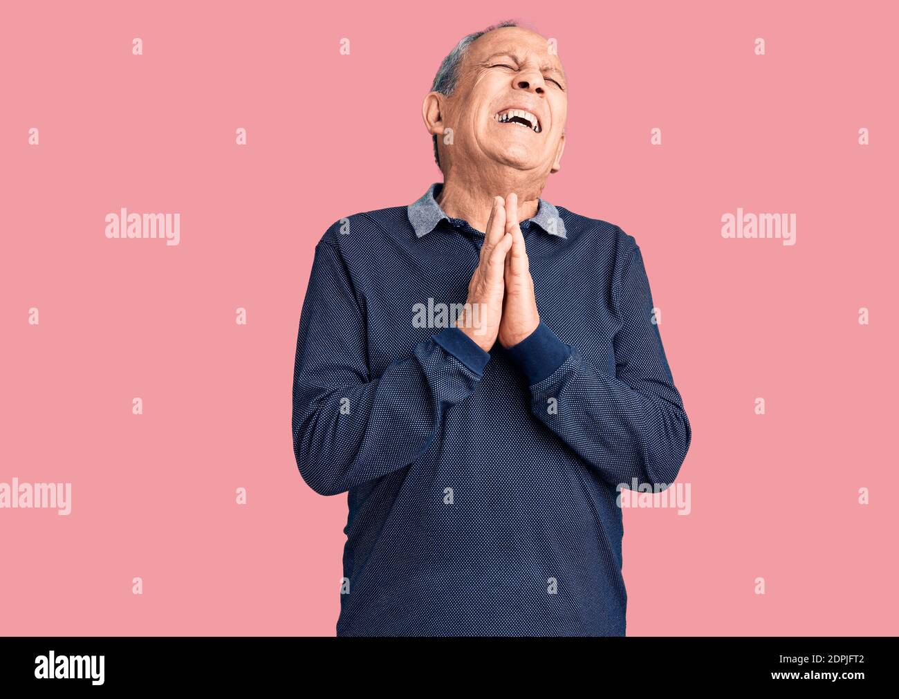 Senior handsome man wearing casual polo begging and praying with hands ...