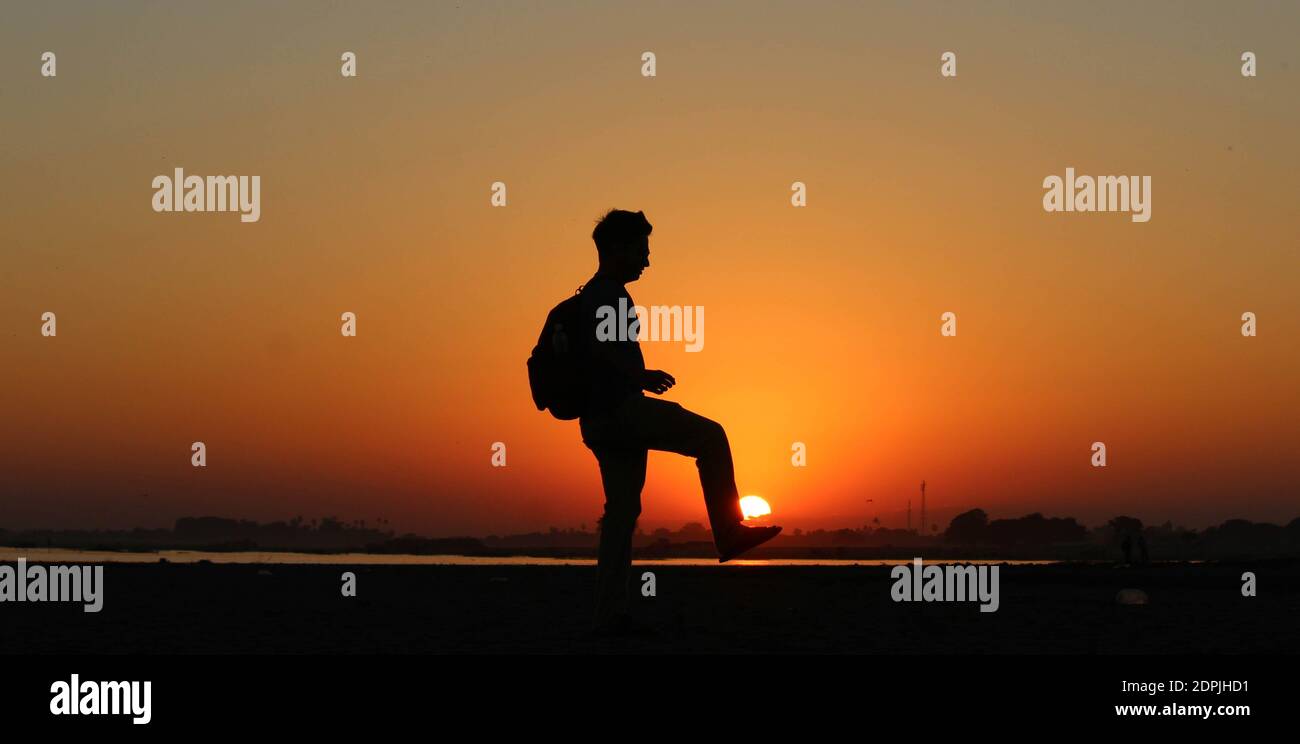 Boy kicking football sunset hi-res stock photography and images - Alamy