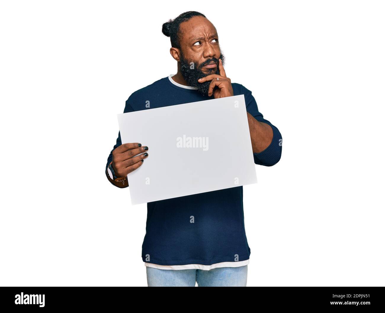Young african american man holding blank empty banner serious face ...