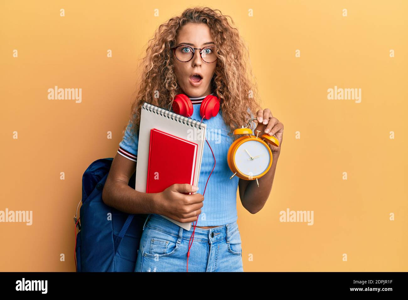 Beautiful caucasian teenager girl wearing student backpack and holding ...