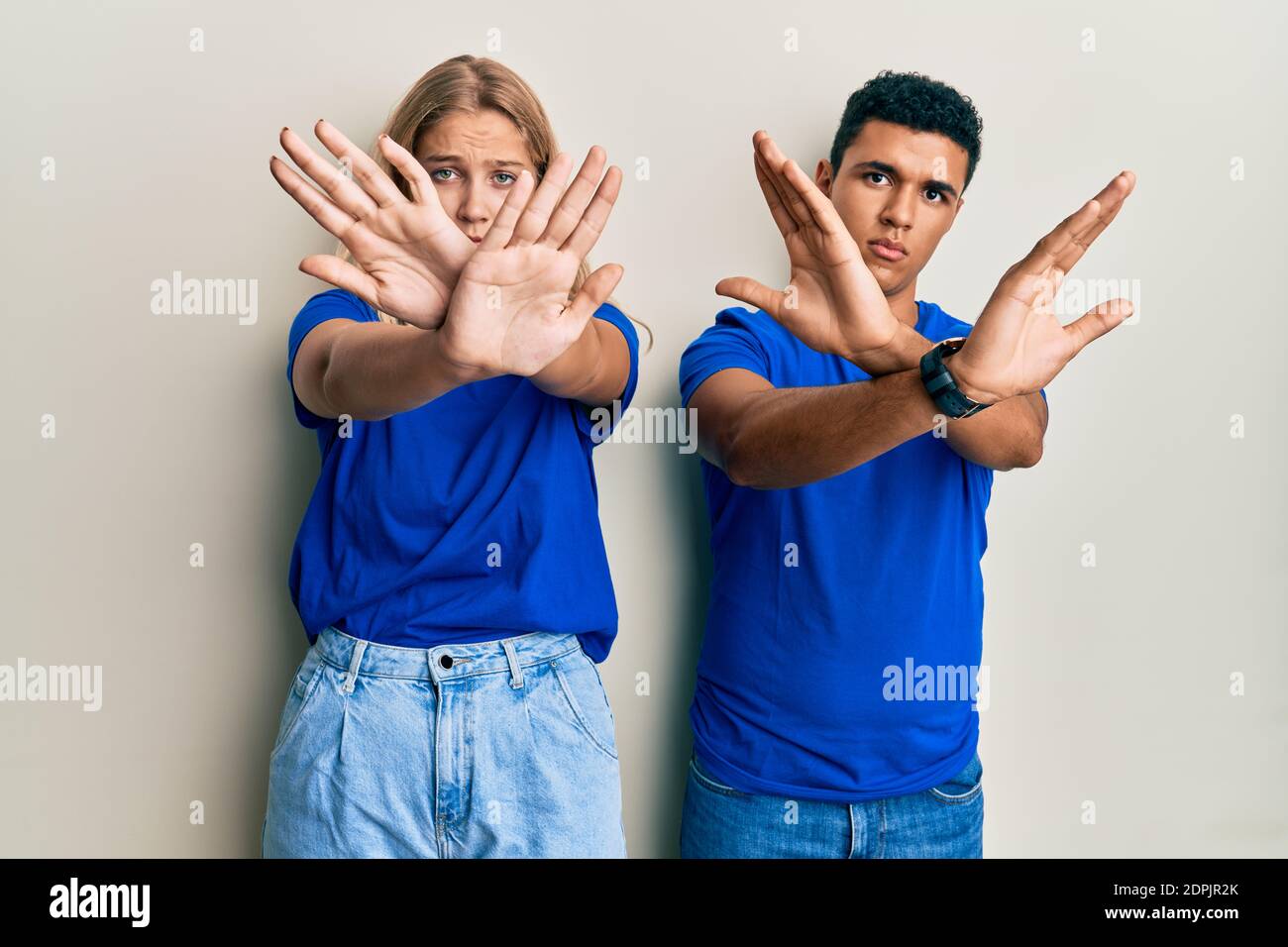 Young interracial couple wearing casual clothes rejection expression ...