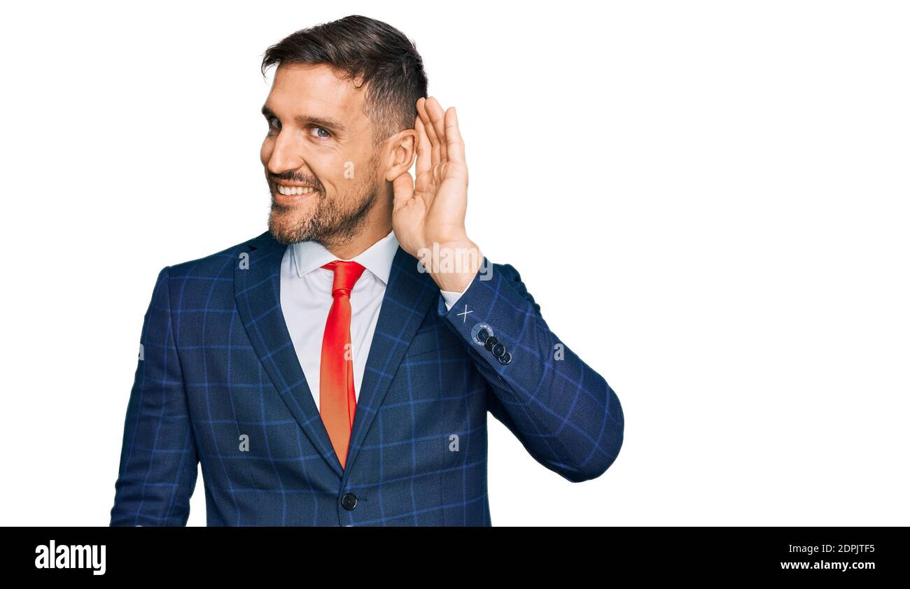 Handsome man with beard wearing business suit and tie smiling with hand ...