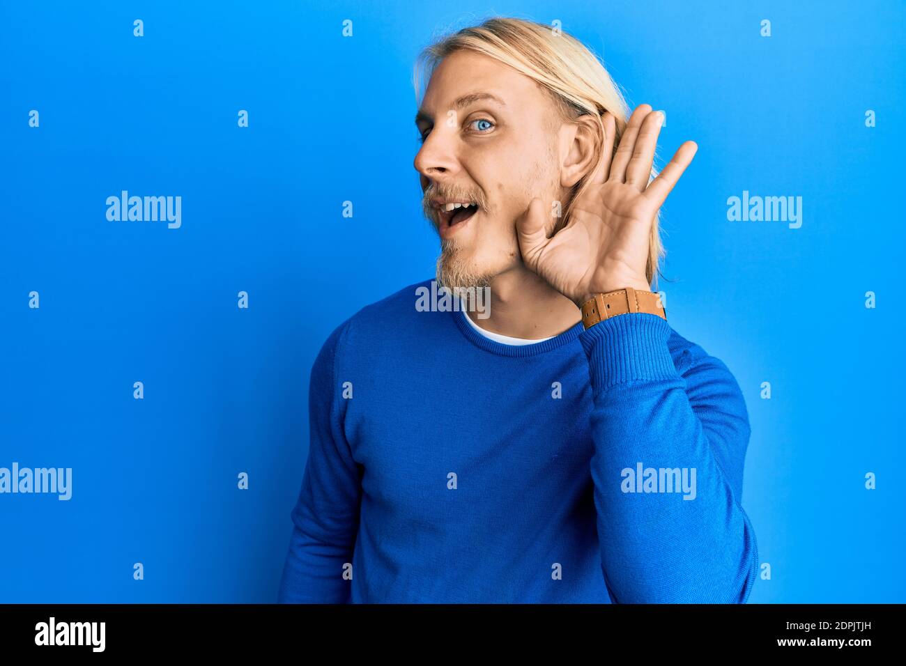 Caucasian young man with long hair wearing casual clothes smiling with ...