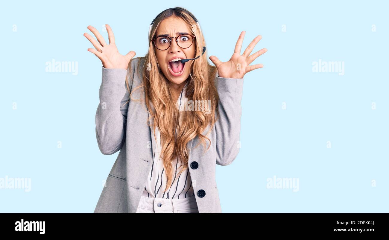 Young beautiful blonde woman wearing call center agent headset ...