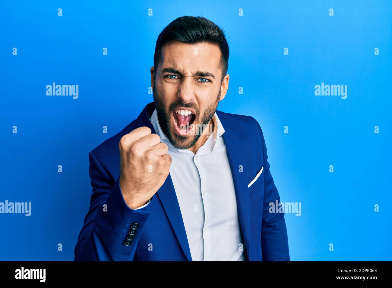 Young hispanic businessman wearing business jacket angry and mad ...