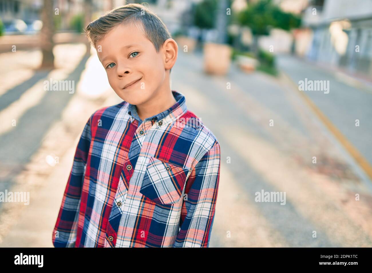 Adorable caucasian boy smiling happy standing at the city Stock Photo - Alamy
