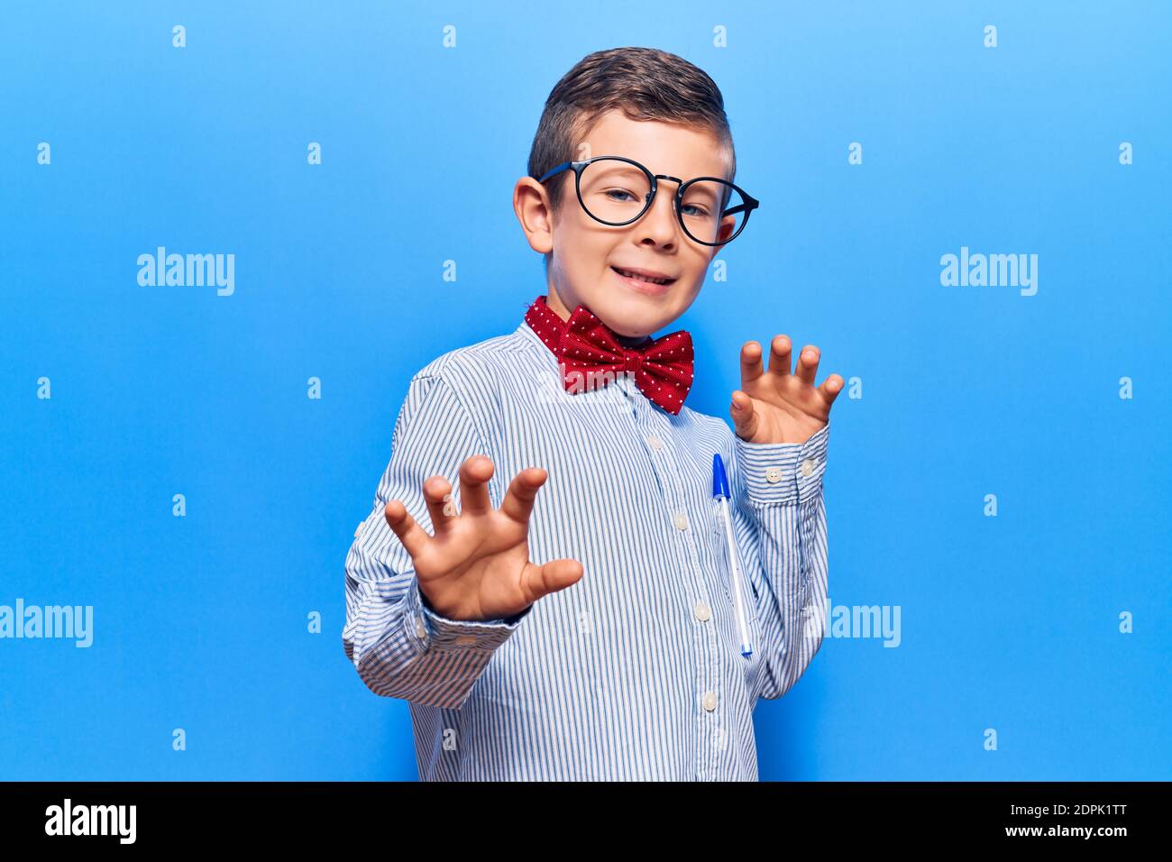 Cute blond kid wearing nerd bow tie and glasses disgusted expression ...