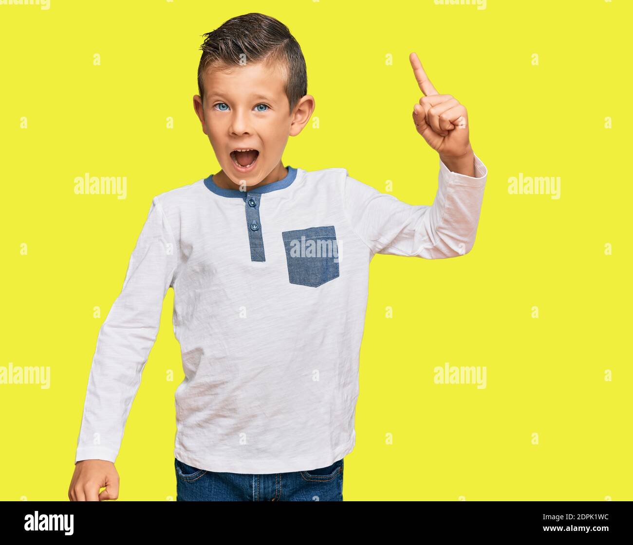Adorable caucasian kid wearing casual clothes pointing finger up with ...
