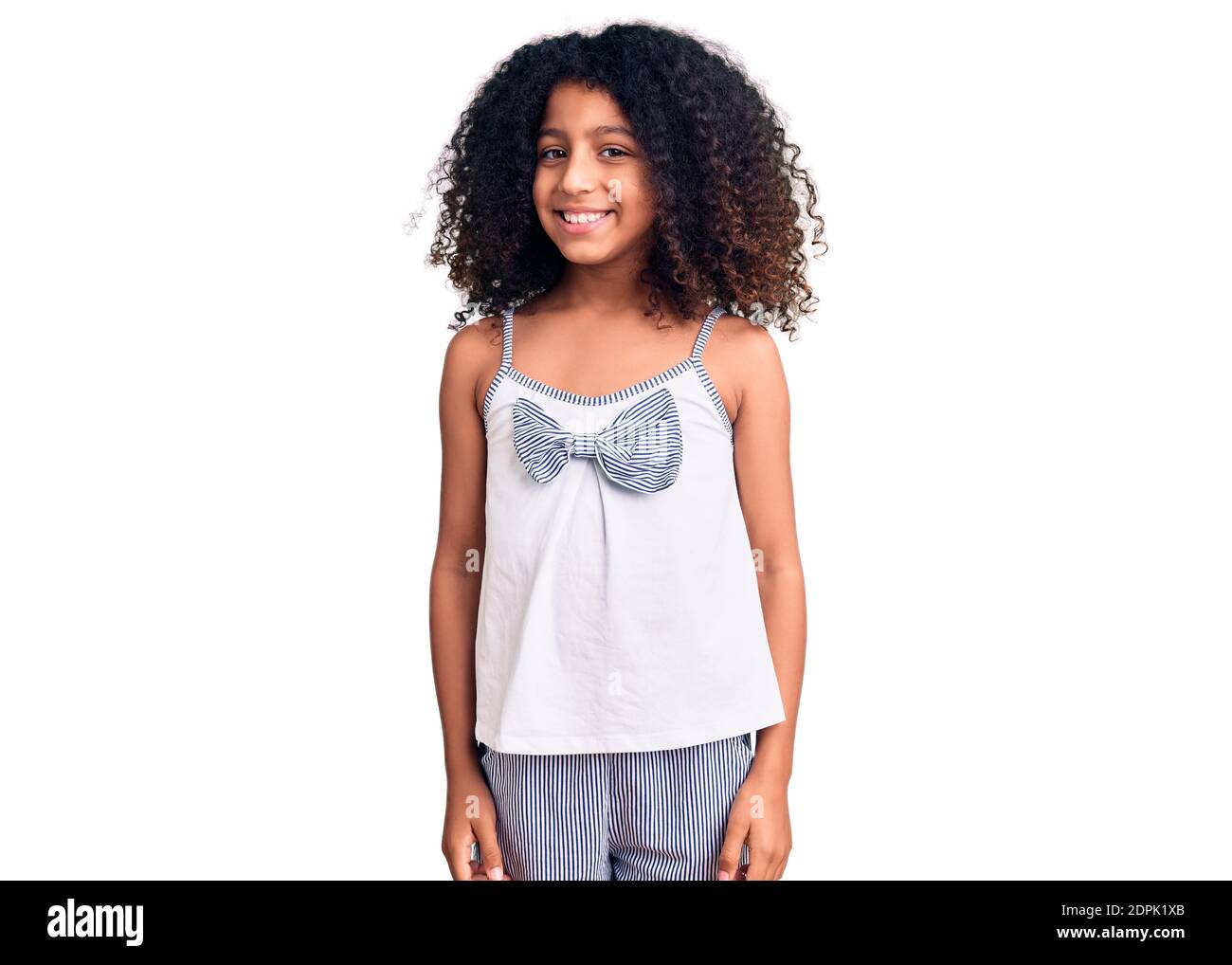 African american child with curly hair wearing casual clothes looking ...