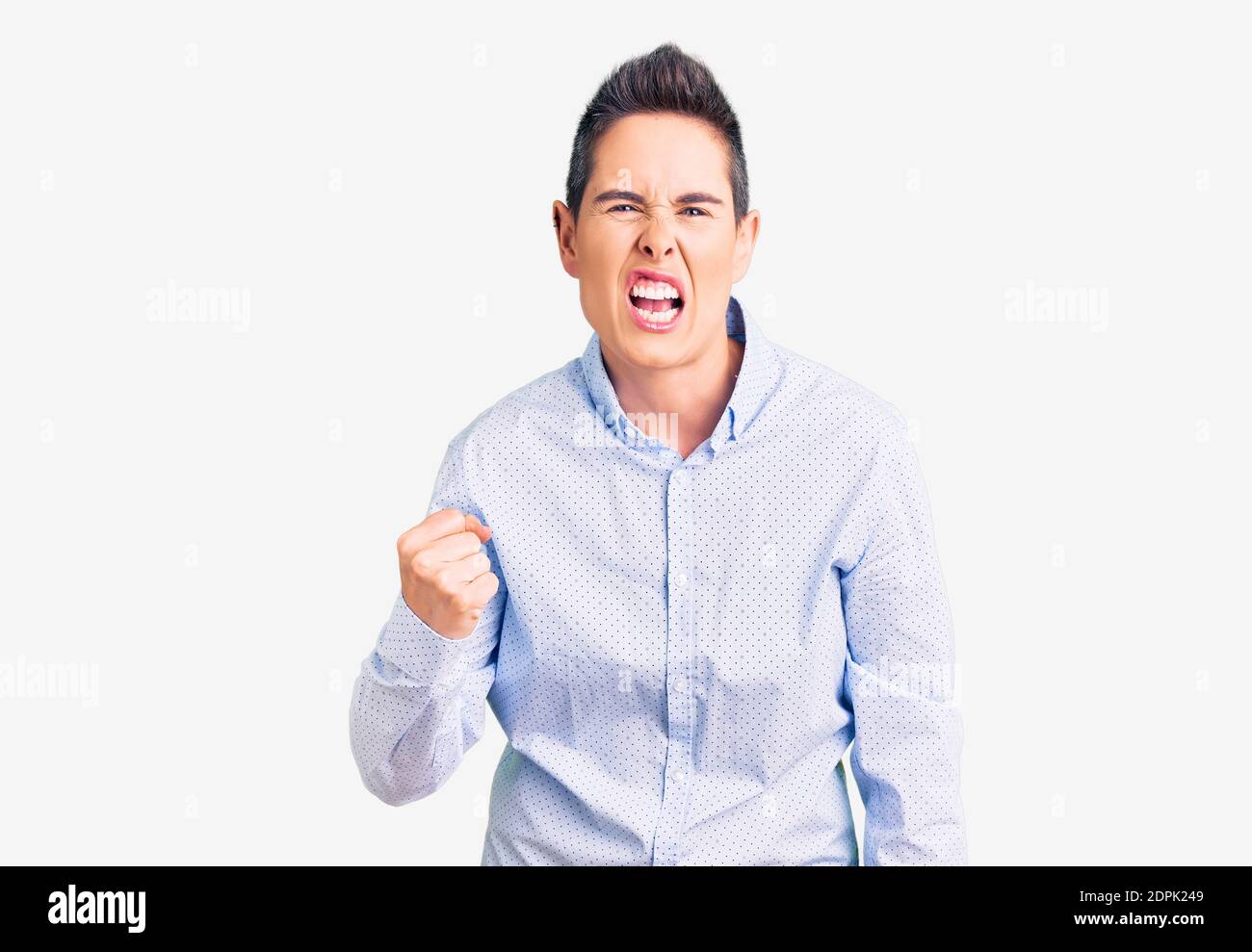 Young woman with short hair wearing business clothes angry and mad ...