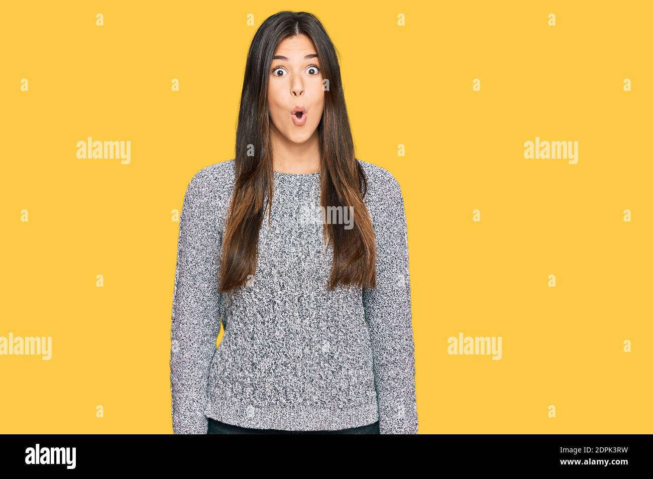 Young brunette woman wearing casual winter sweater afraid and shocked ...