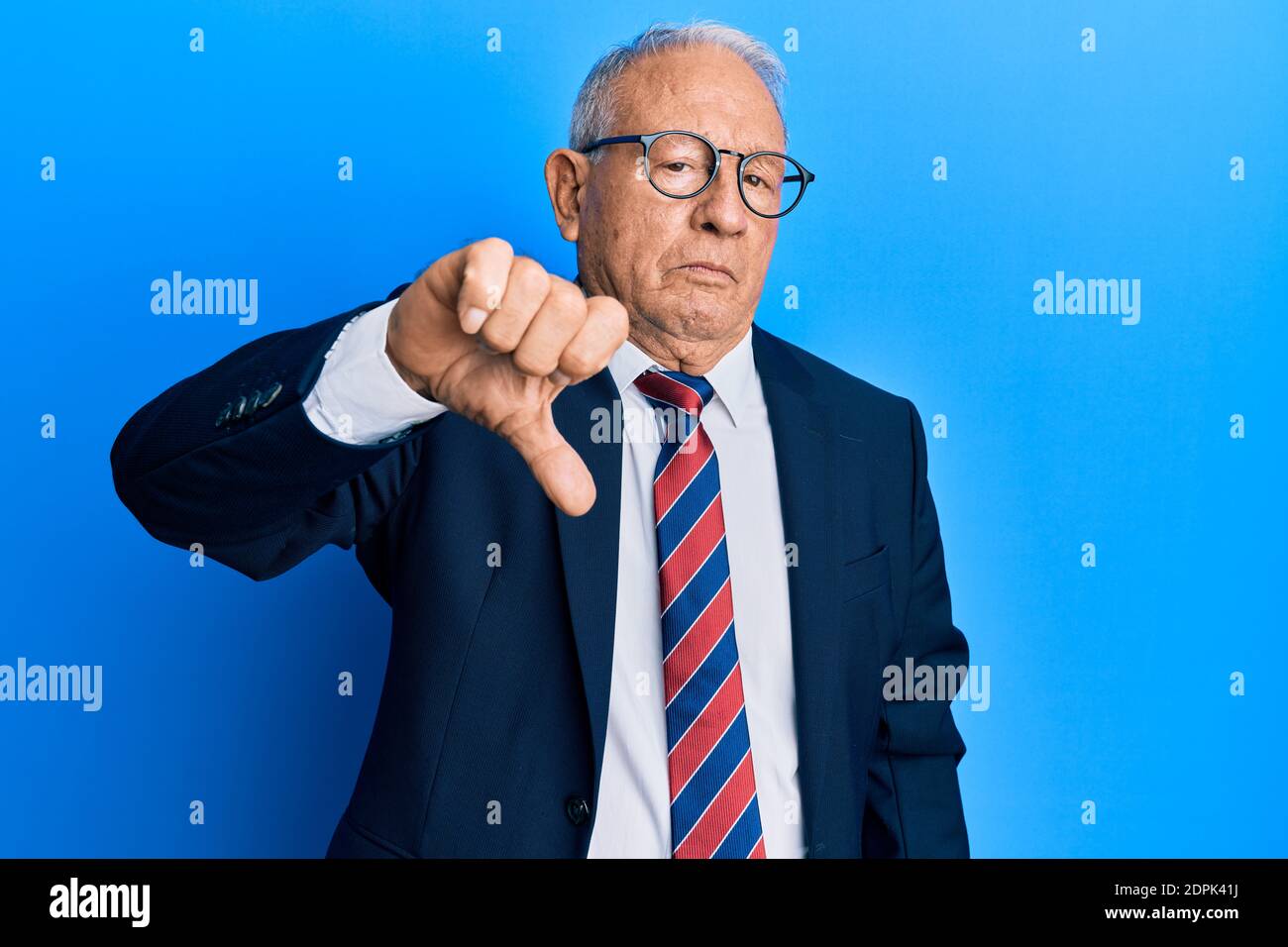 Senior caucasian man wearing business suit and tie looking unhappy and ...