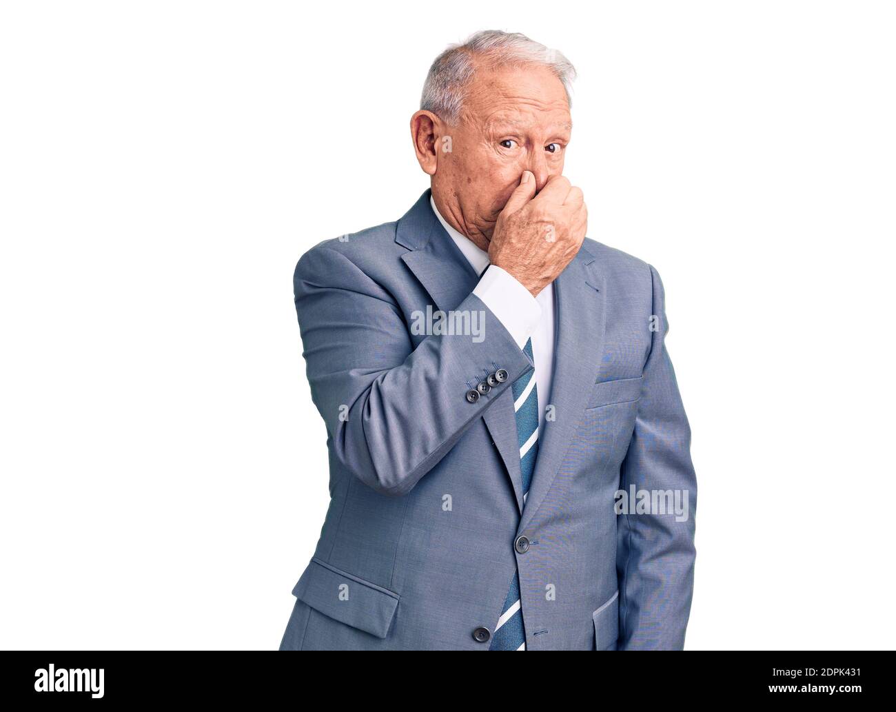 Senior handsome grey-haired man wearing elegant suit smelling something ...