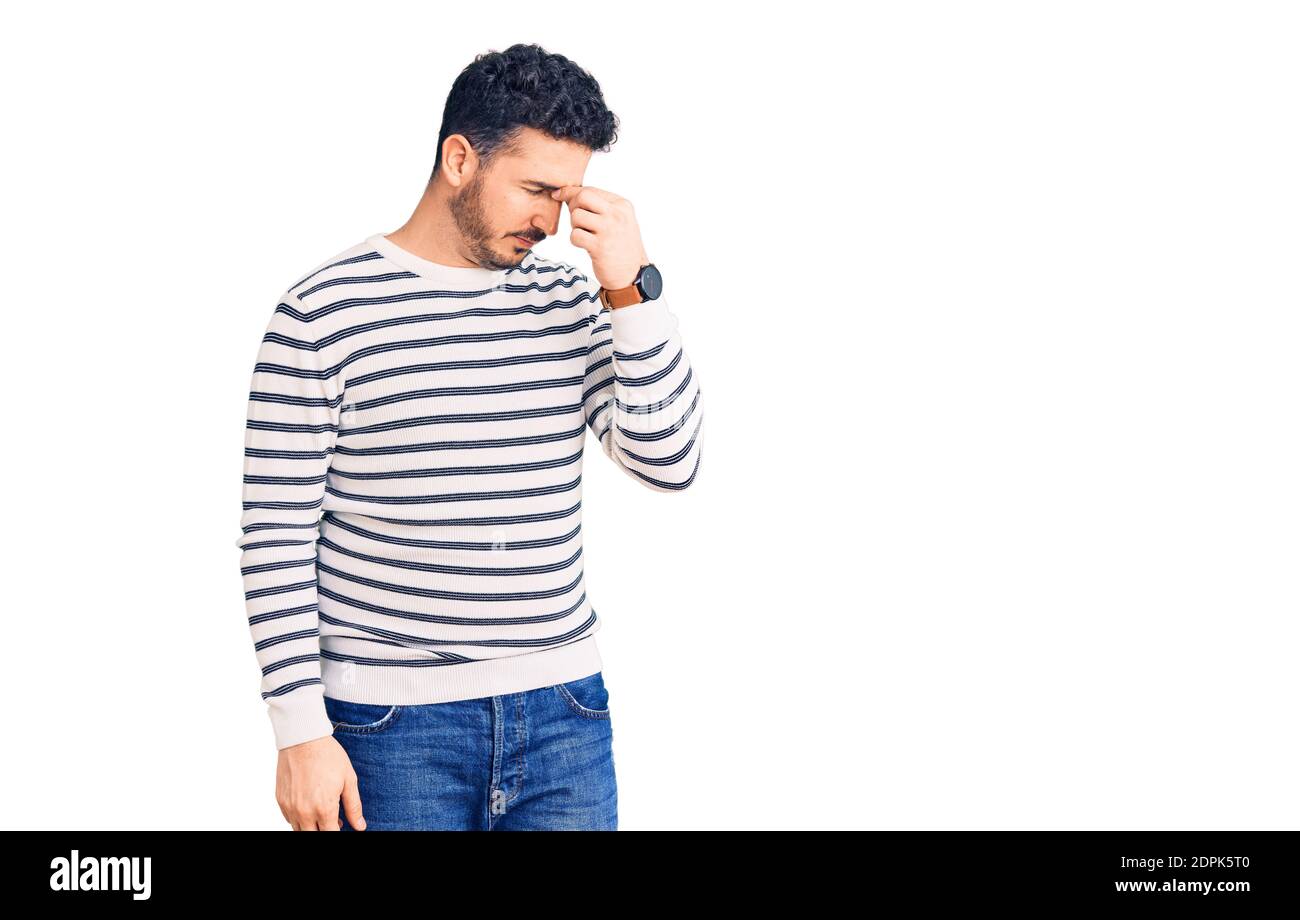 Young hispanic man wearing casual clothes tired rubbing nose and eyes ...