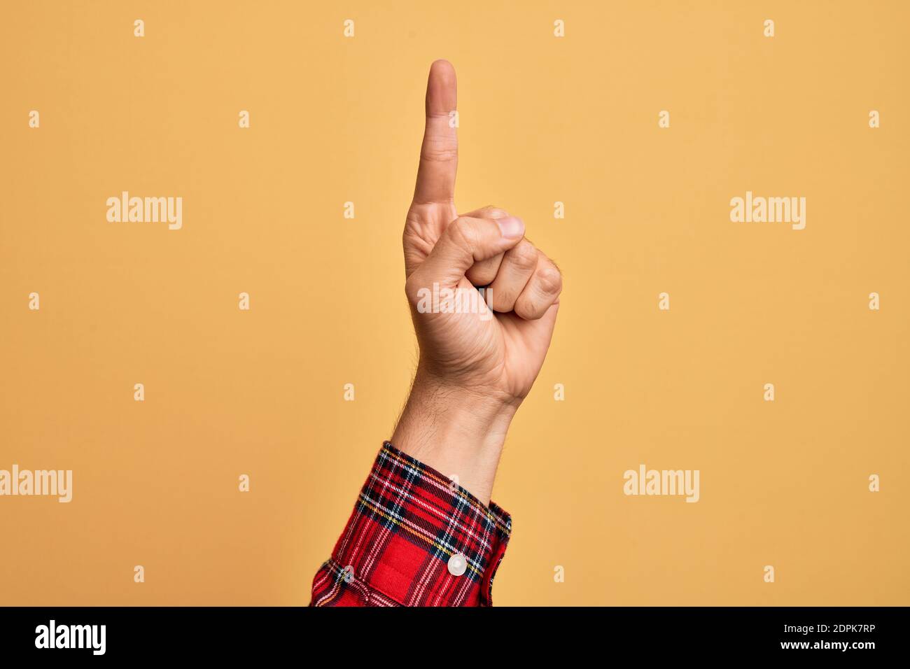 Hand of caucasian young man showing fingers over isolated yellow ...