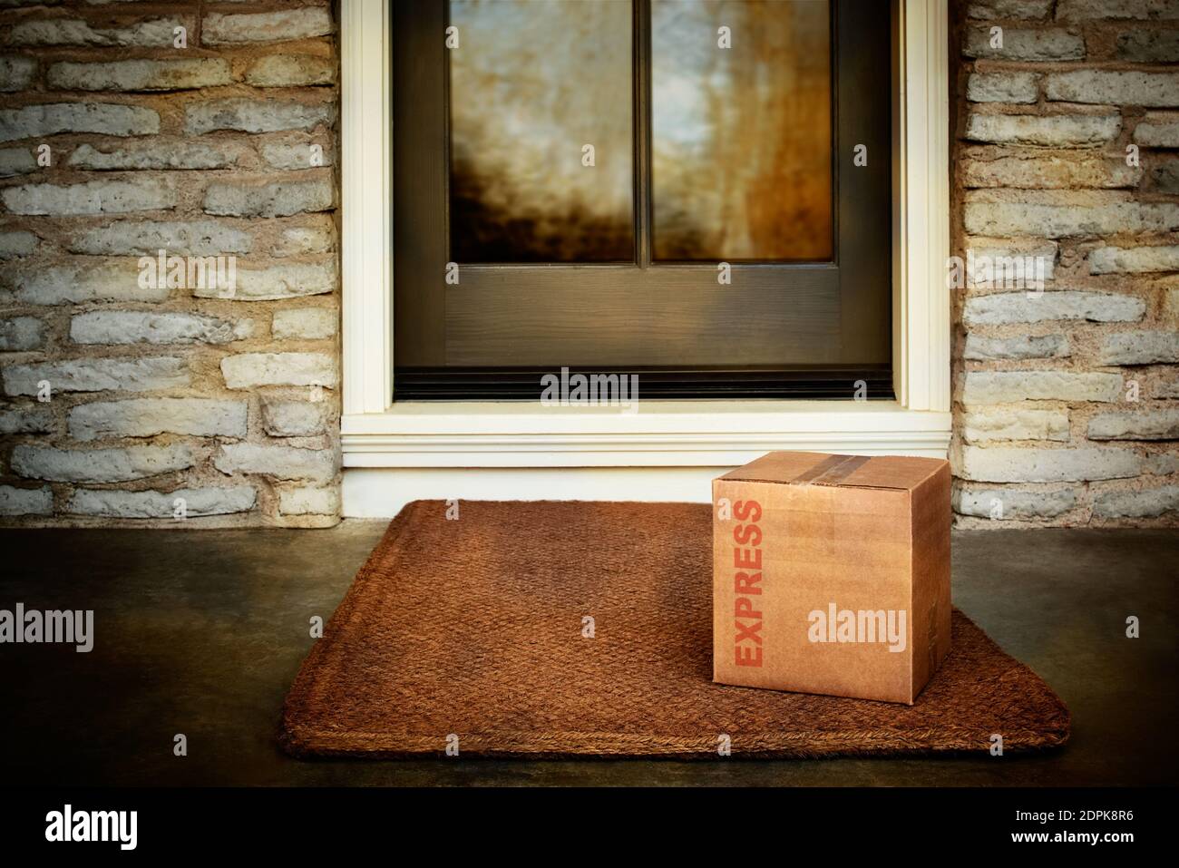 Overnight express box delivered outside front door Stock Photo - Alamy