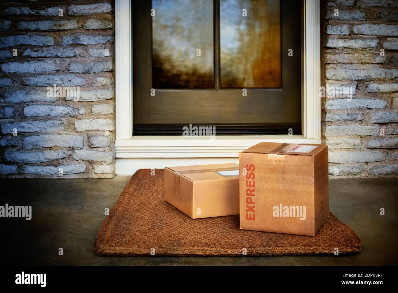 Overnight express delivery boxes outside front door of home Stock Photo ...
