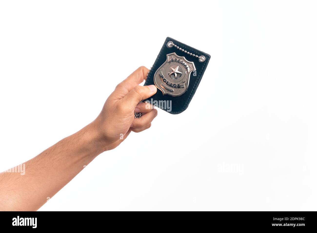 Hand of caucasian young man holding police badge over isolated white ...
