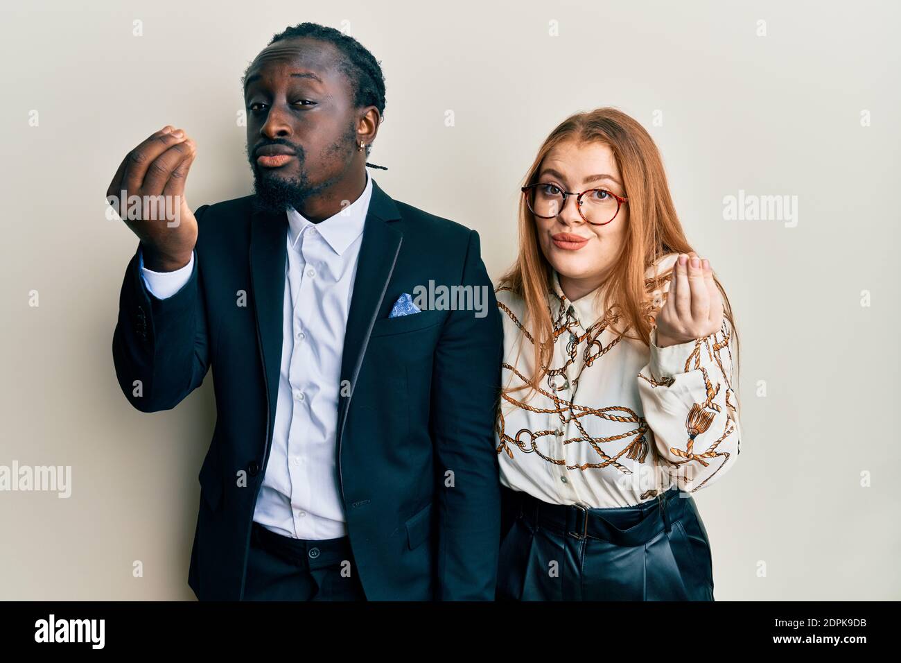 Young Interracial Couple Wearing Business And Elegant Clothes Doing