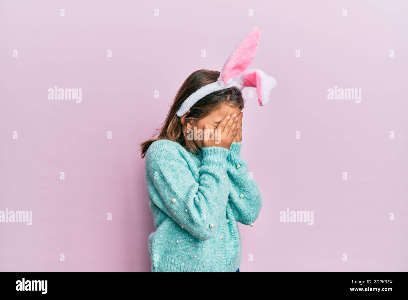 Little beautiful girl wearing cute easter bunny ears with sad ...