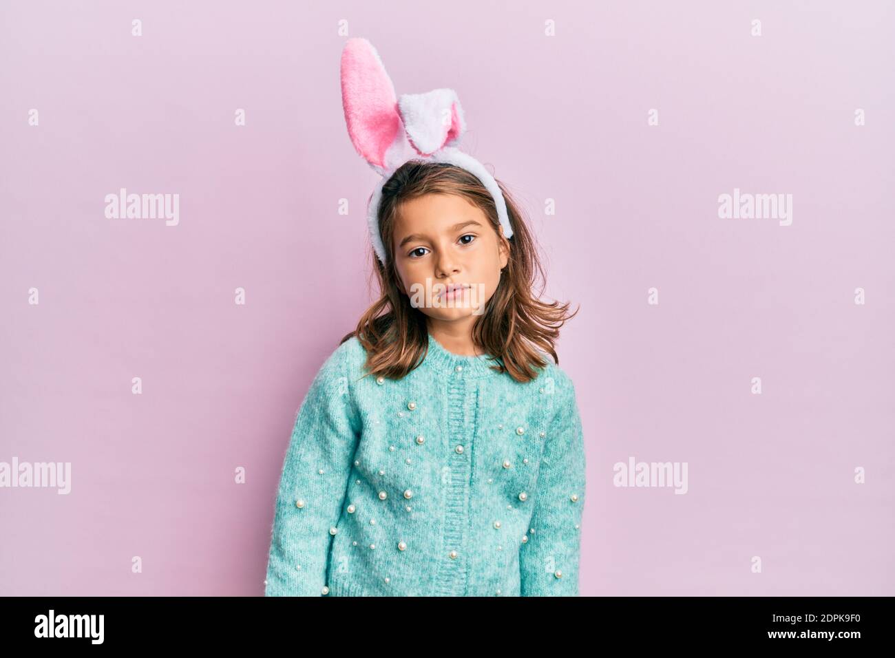 Little beautiful girl wearing cute easter bunny ears relaxed with ...