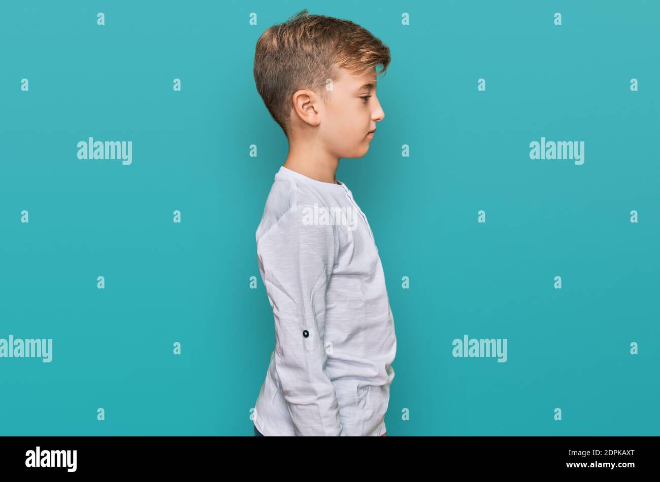 Little caucasian boy kid wearing casual clothes looking to side, relax ...