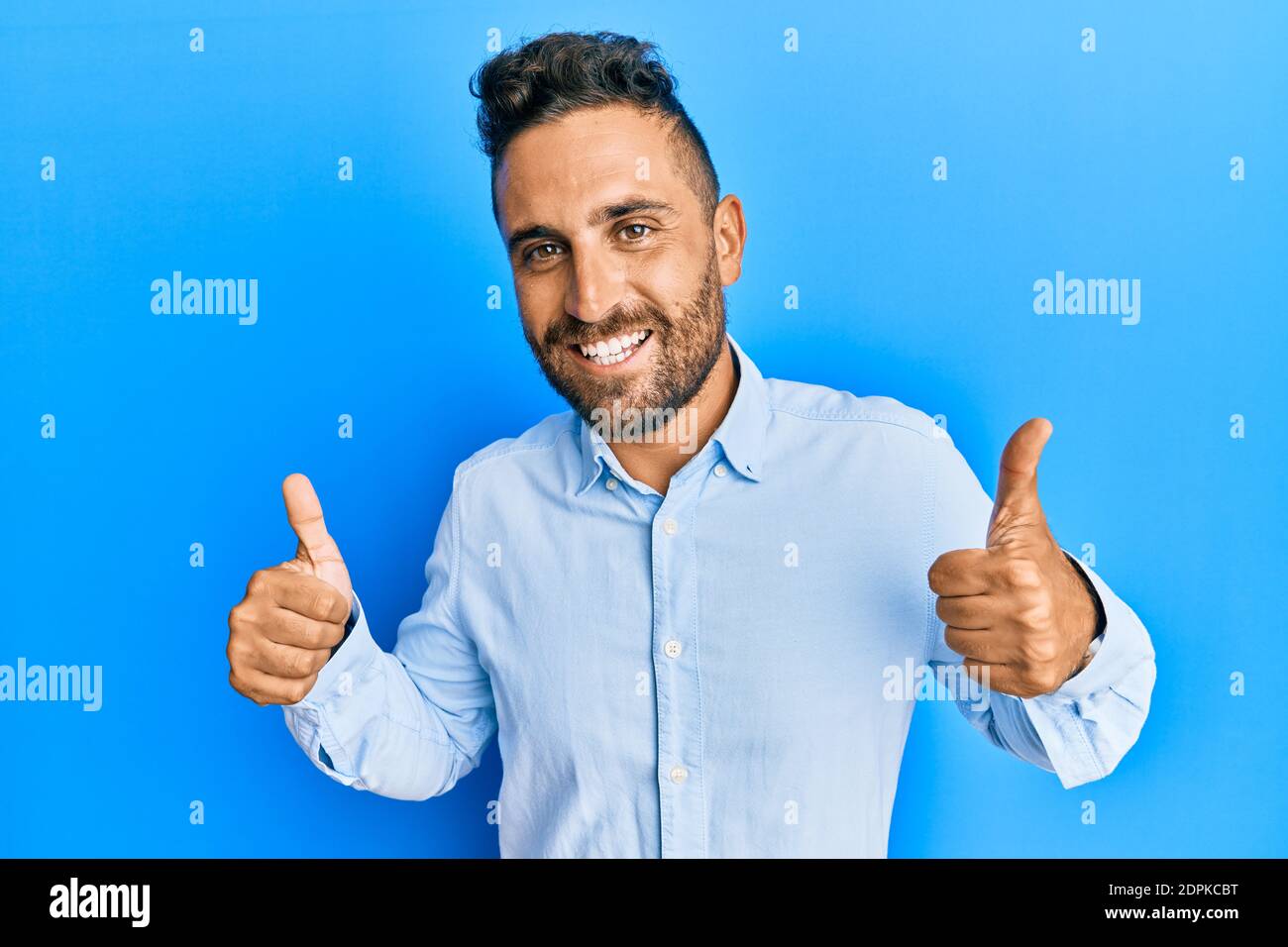 Handsome man with beard wearing casual clothes success sign doing ...