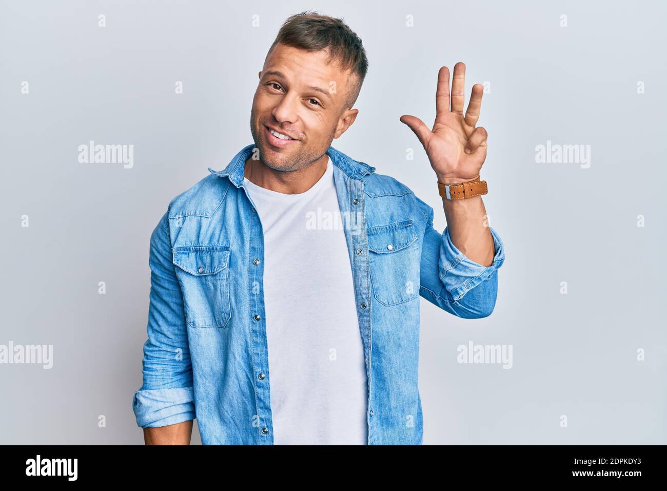 Handsome muscle man wearing casual denim jacket showing and pointing up ...