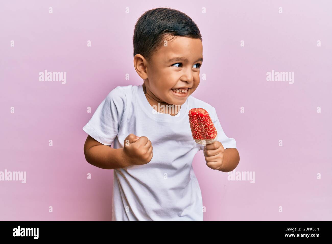 Adorable latin toddler holding ice cream screaming proud, celebrating ...