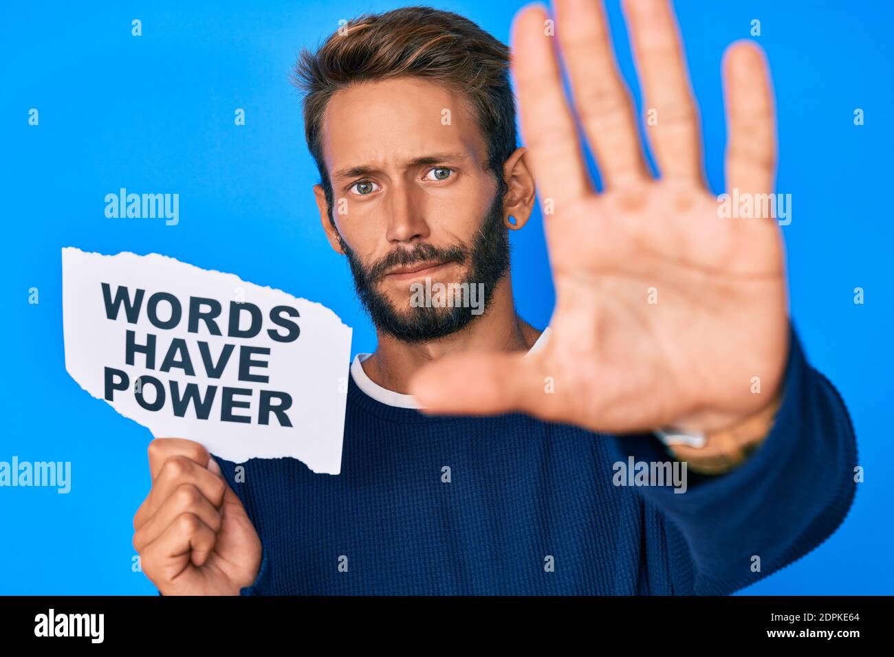 Handsome caucasian man with beard showing words have power banner with ...