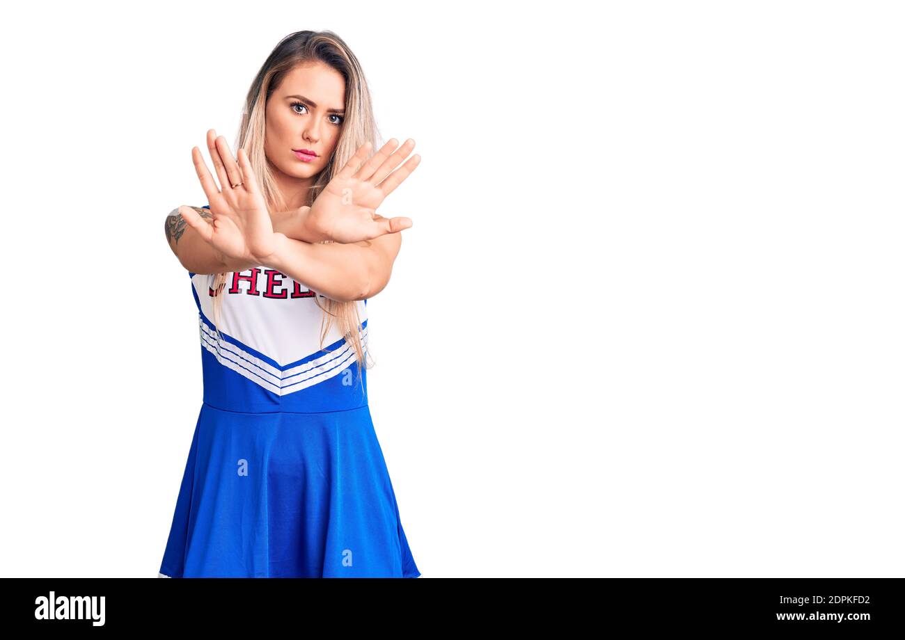 Young beautiful blonde woman wearing cheerleader uniform rejection ...